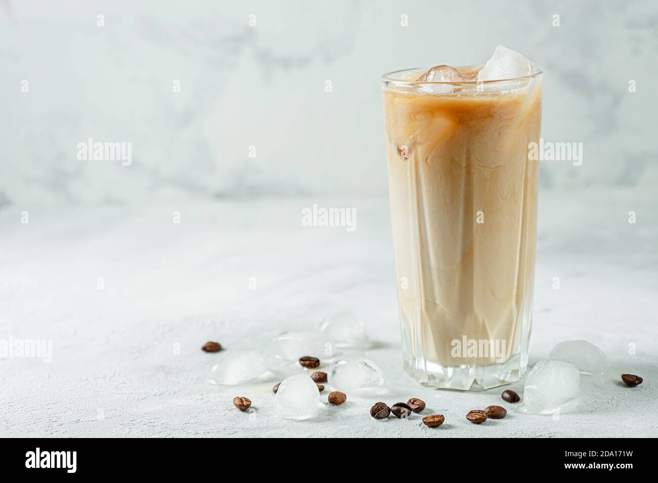 Refreshing cold Greek coffee frappe on gray stone background. Copy ...