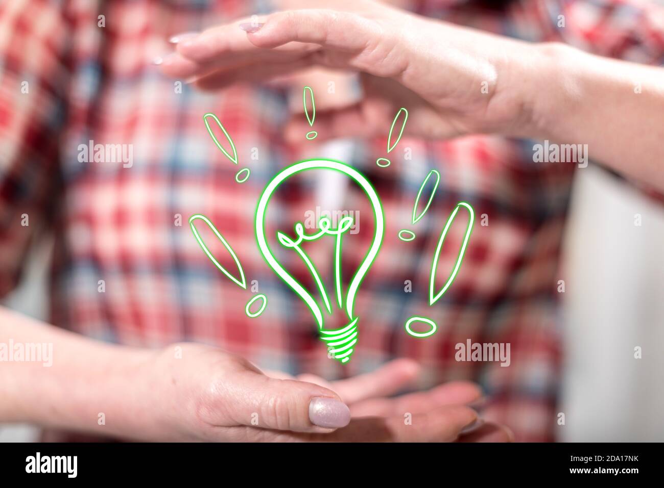 Idea concept between hands of a woman in background Stock Photo - Alamy
