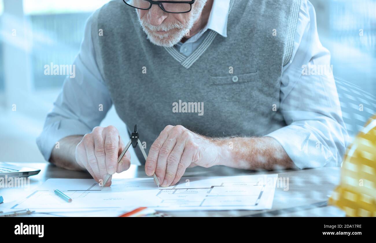 Architect working on a project and using a compass; light effect Stock ...