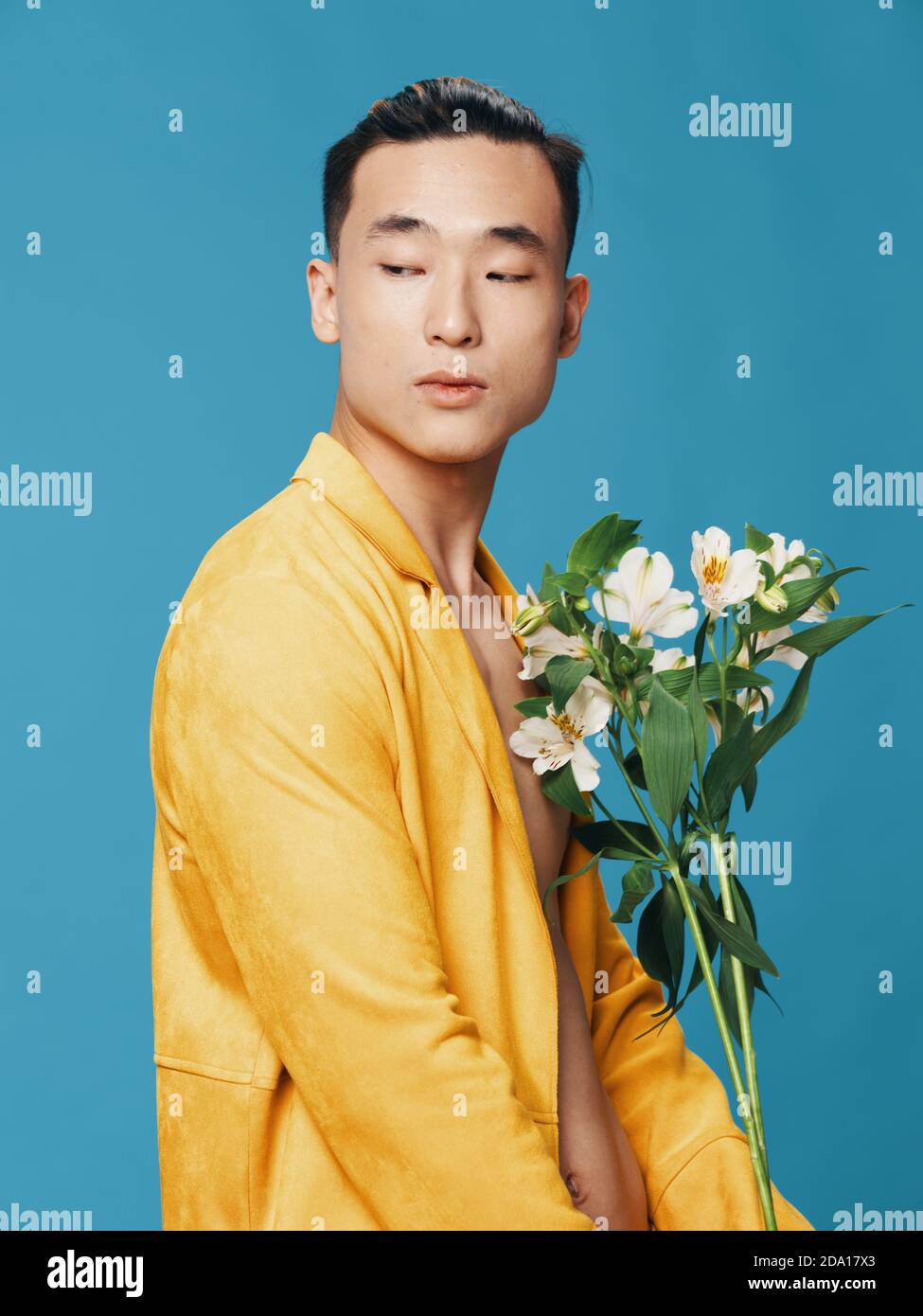 guy in yellow coat asian appearance bouquet of white flowers and blue ...