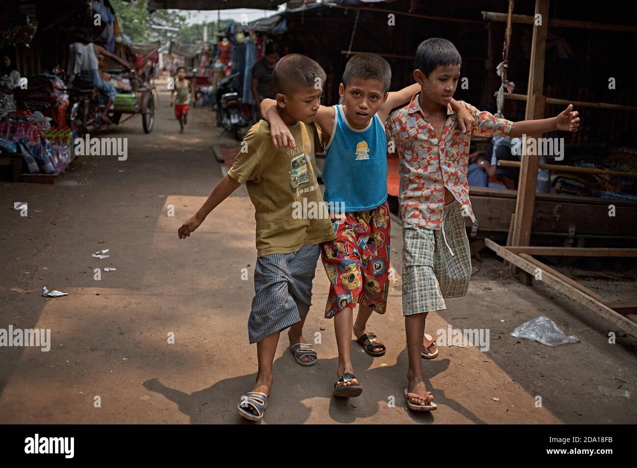 Myawaddy, Myanmar. April 2012. Three children hugged in a slum along ...