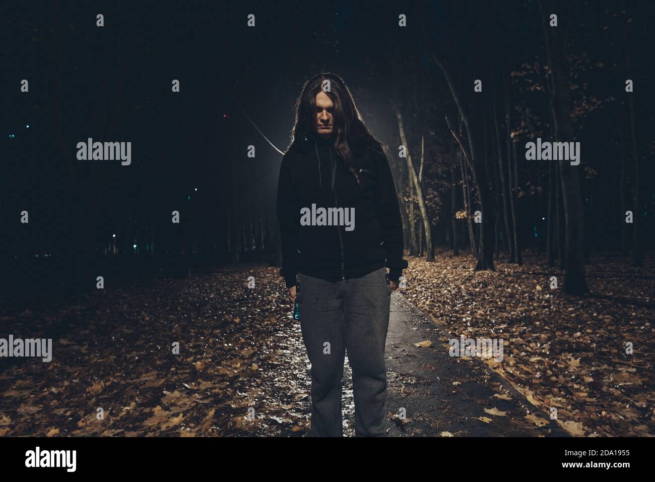 Sad man alone walking along the alley in night foggy park Stock Photo ...