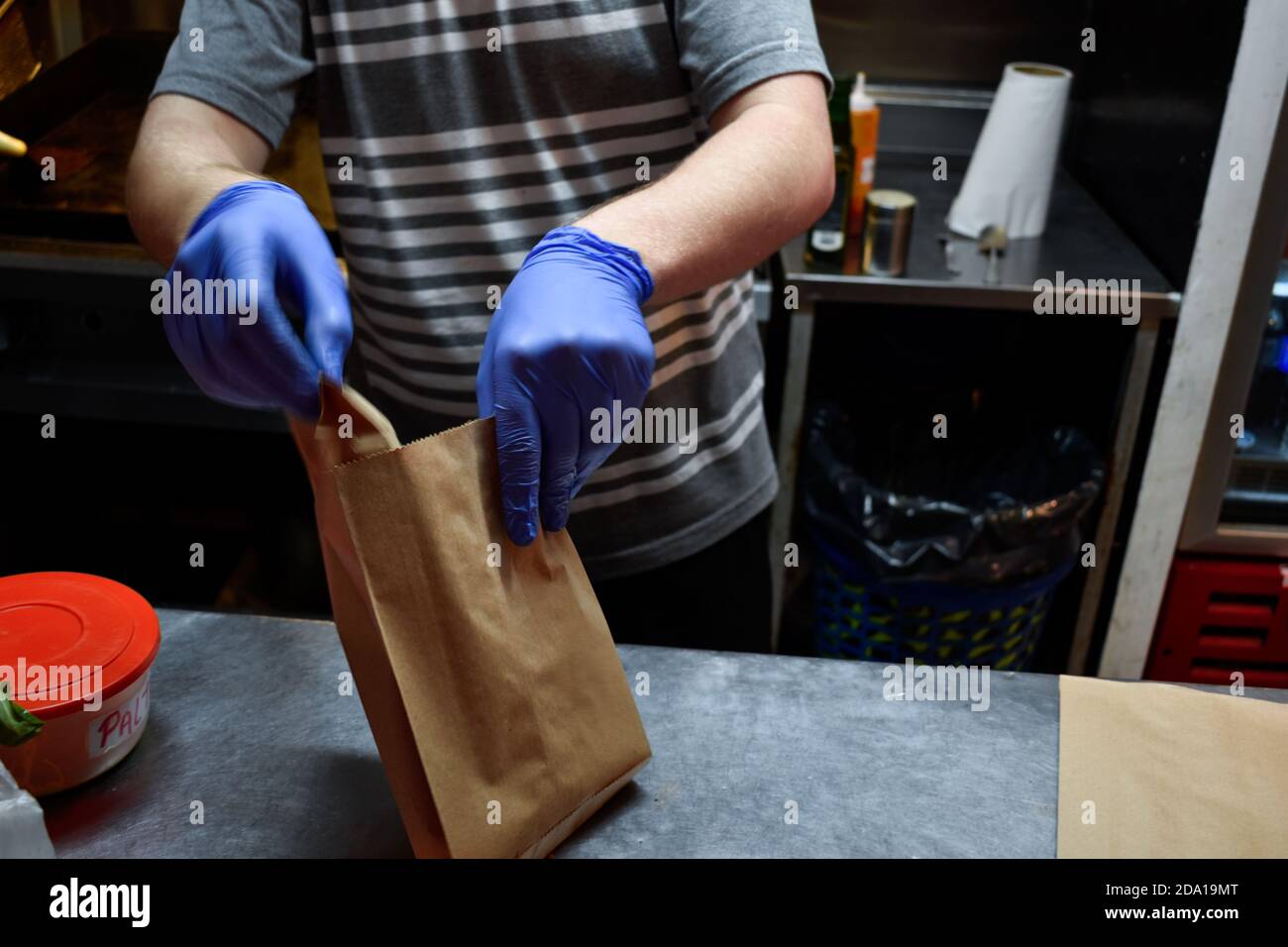 packing fast food delivery with biosecurity protocols Stock Photo - Alamy