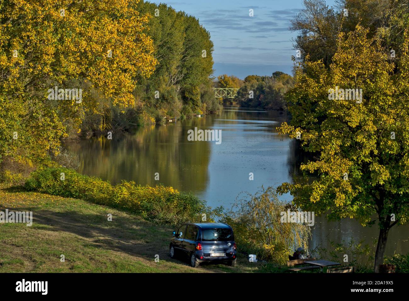 Tamis River in Banat. The fisherman enjoys the shore as the river flows ...