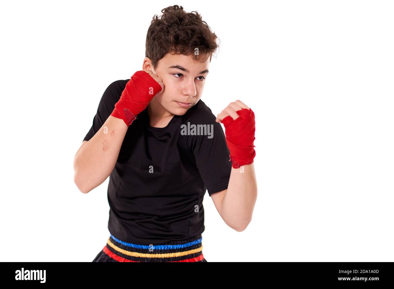 Young kickboxer training shadow boxing, isolated on white background ...