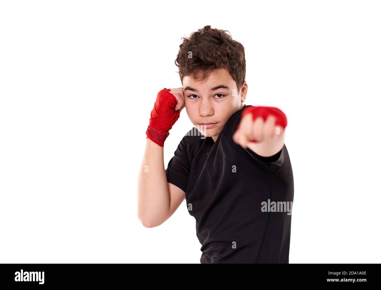 Young kickboxer training shadow boxing, isolated on white background ...