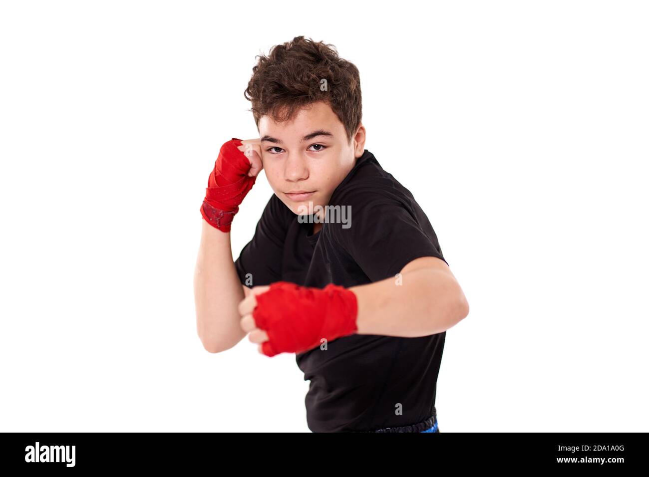 Young kickboxer training shadow boxing, isolated on white background ...