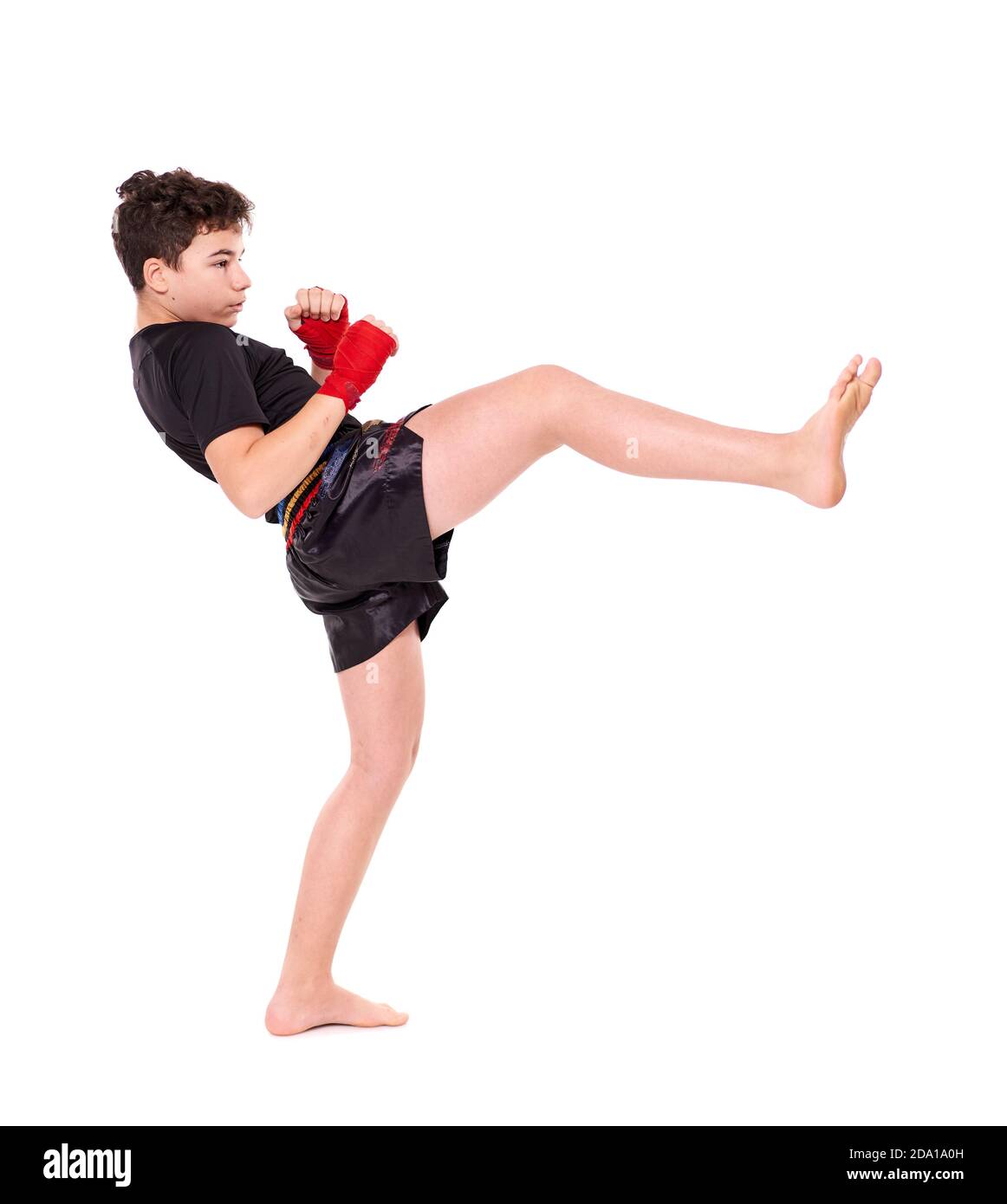 Young kickboxer training shadow boxing, isolated on white background ...