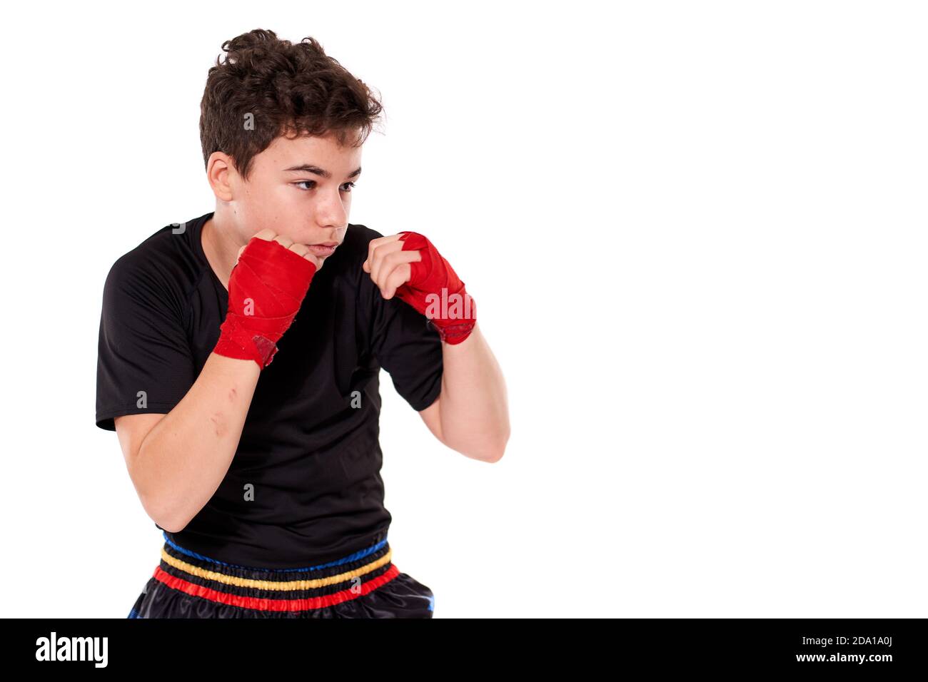 Young kickboxer training shadow boxing, isolated on white background ...