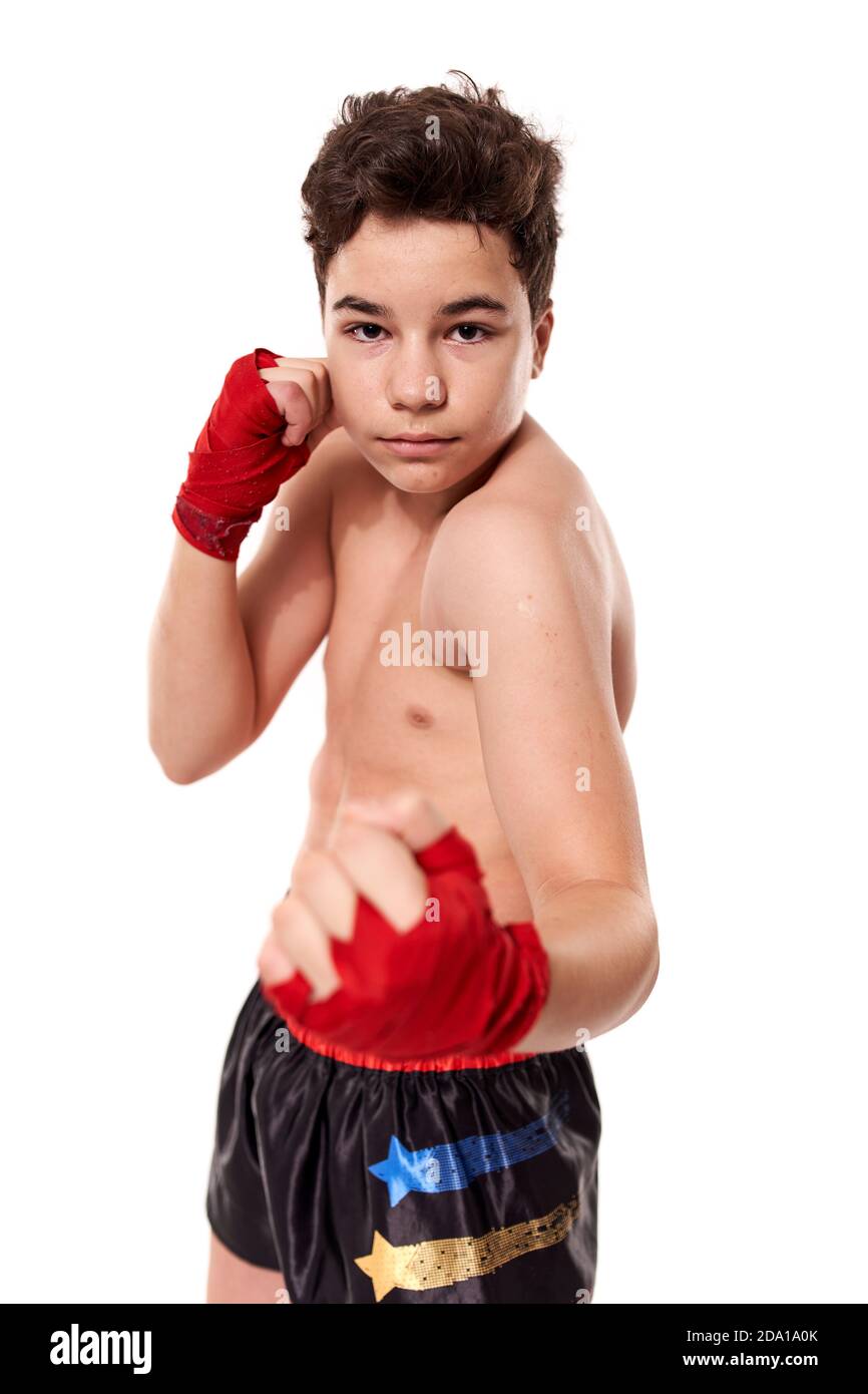 Young kickboxer training shadow boxing, isolated on white background ...