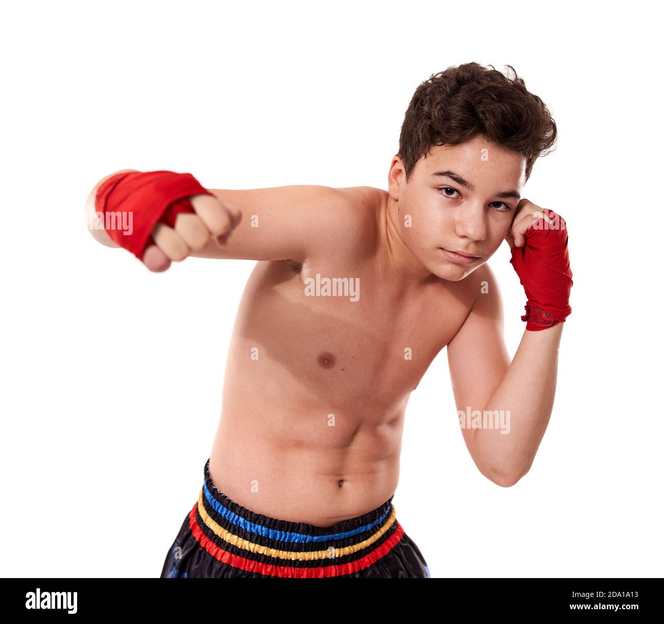 Young kickboxer training shadow boxing, isolated on white background ...