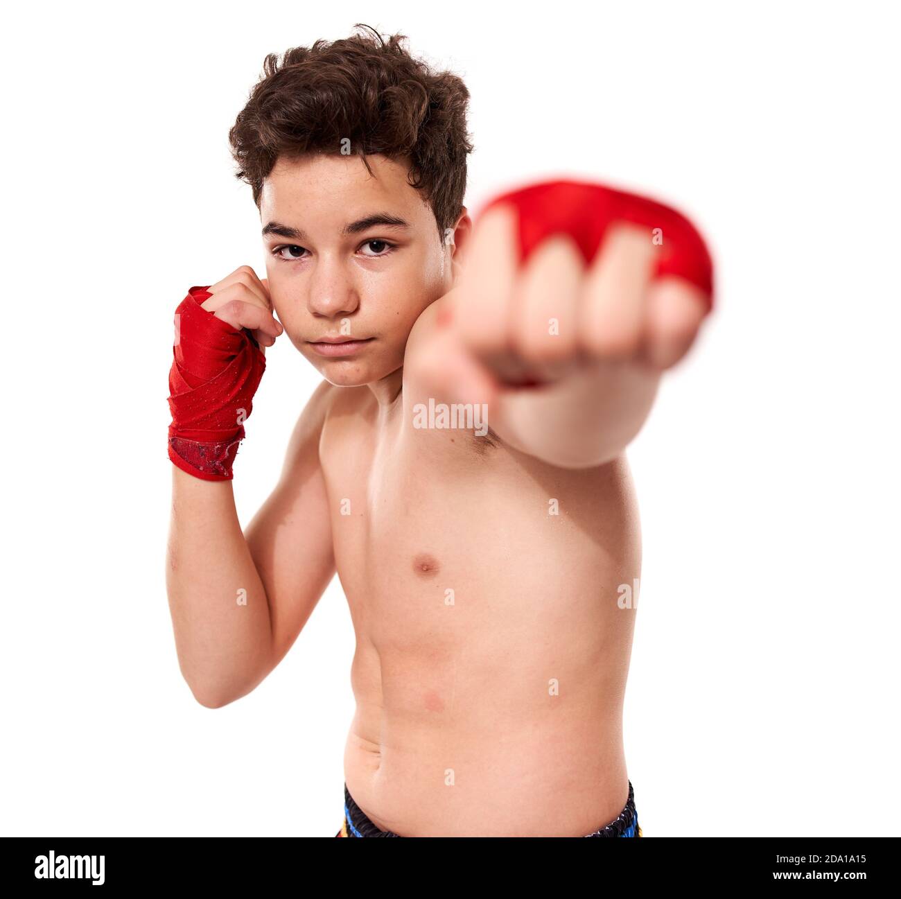 Young kickboxer training shadow boxing, isolated on white background ...