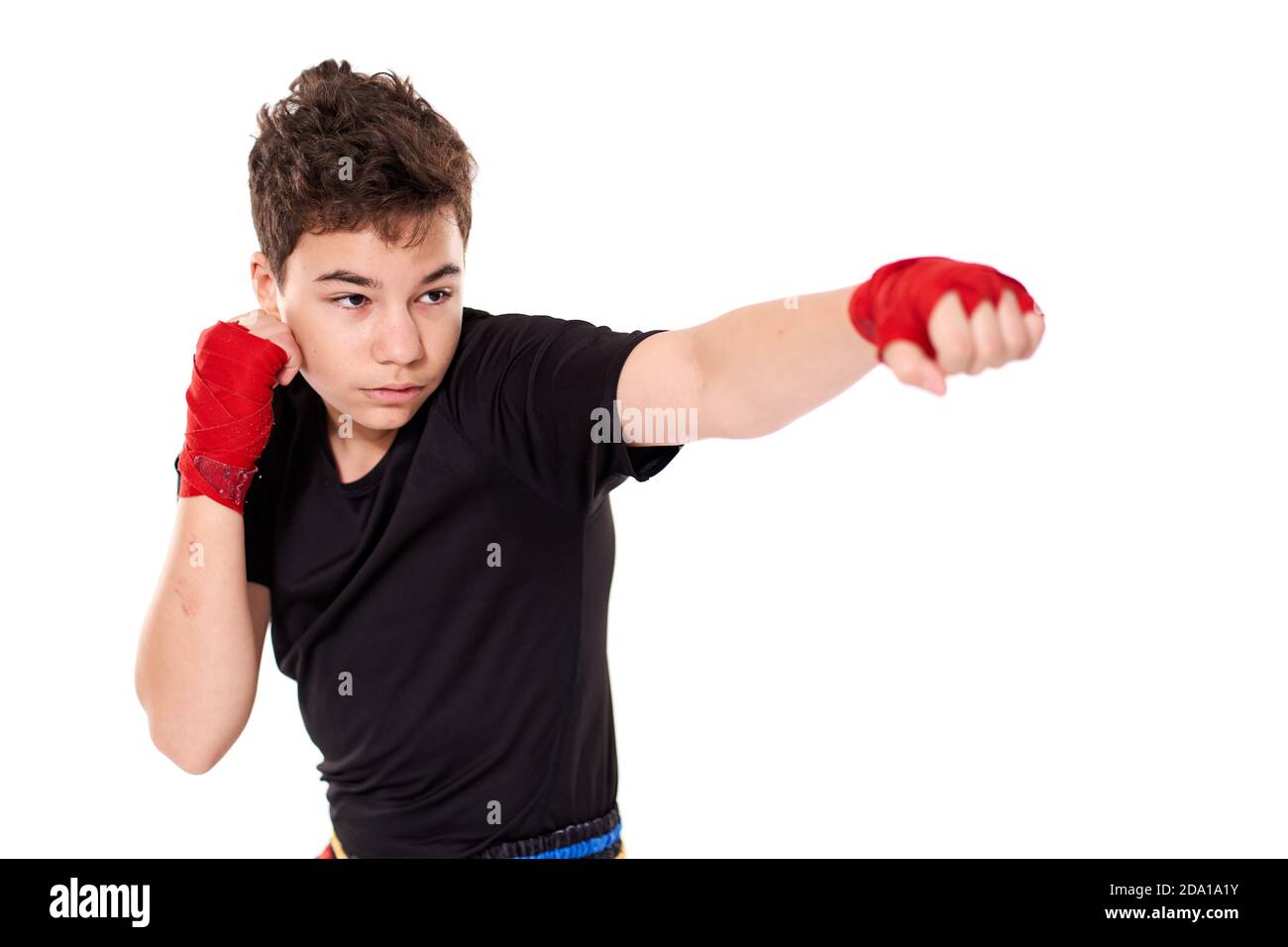 Young kickboxer training shadow boxing, isolated on white background ...