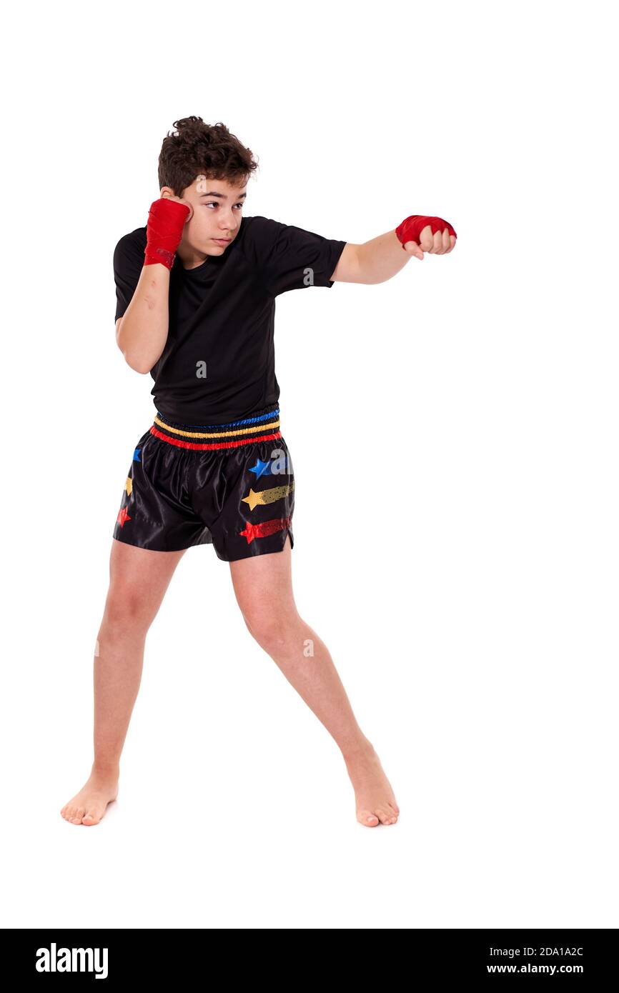 Young kickboxer training shadow boxing, isolated on white background ...