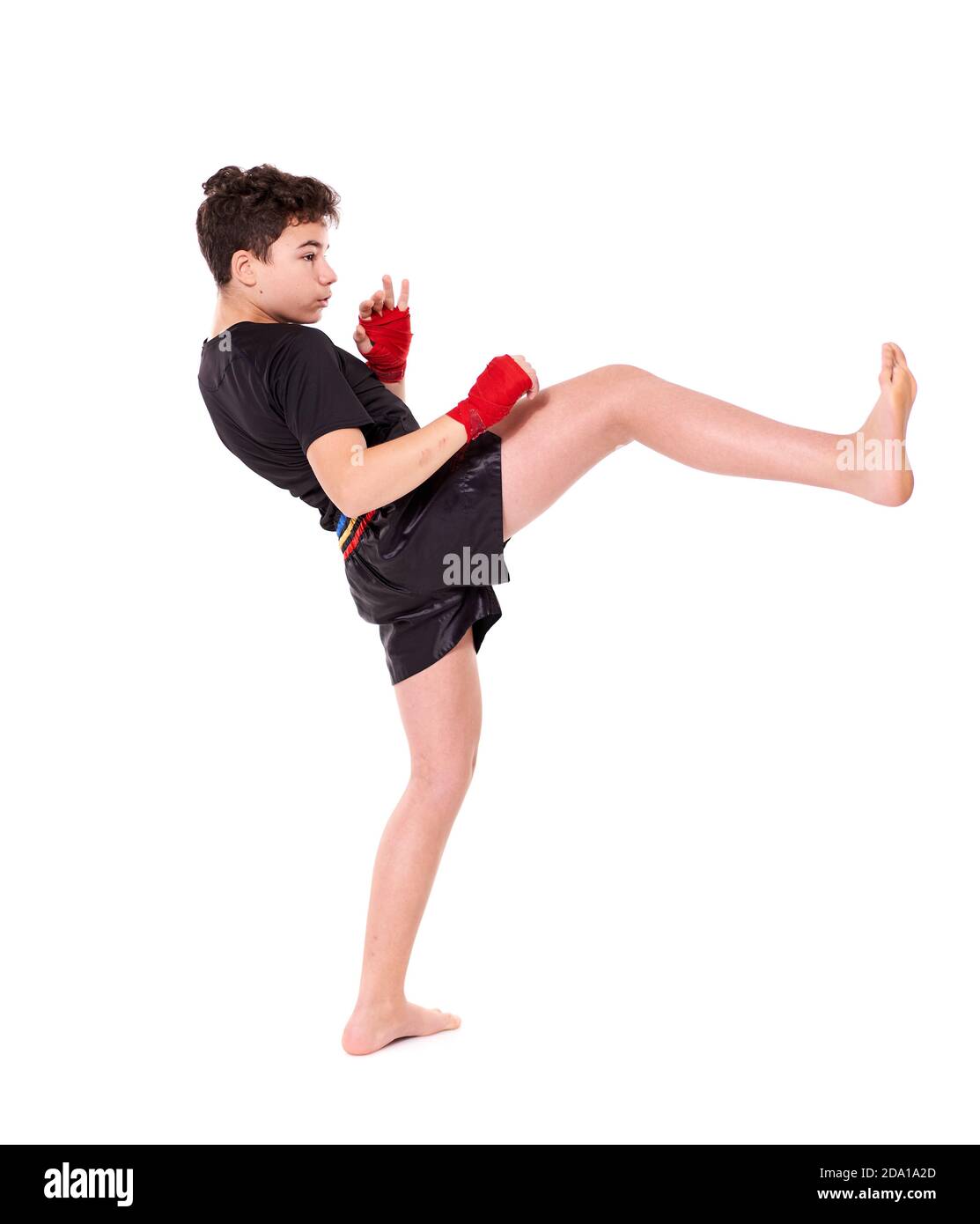 Young kickboxer training shadow boxing, isolated on white background ...
