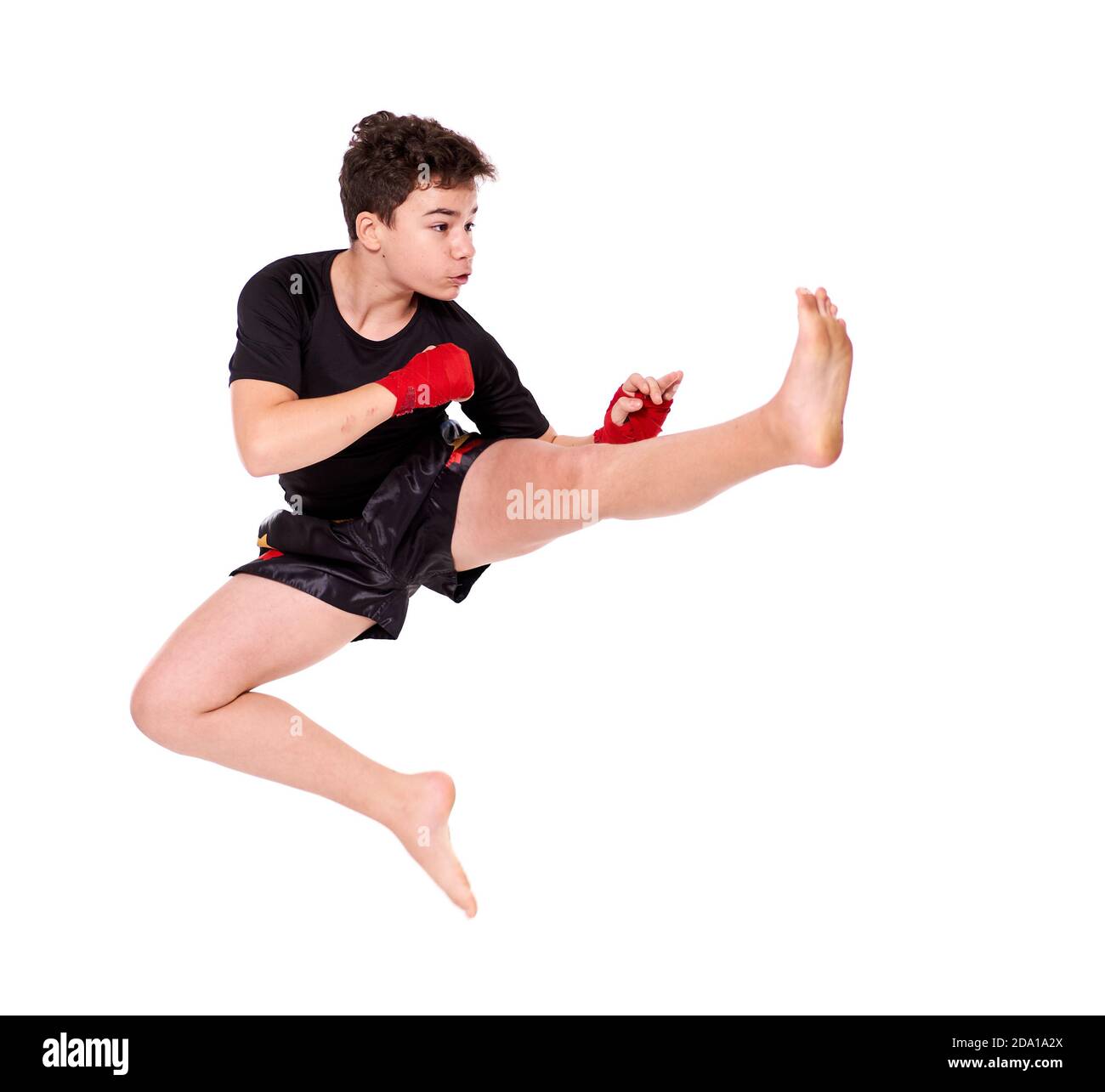 Young kickboxer training shadow boxing, isolated on white background ...