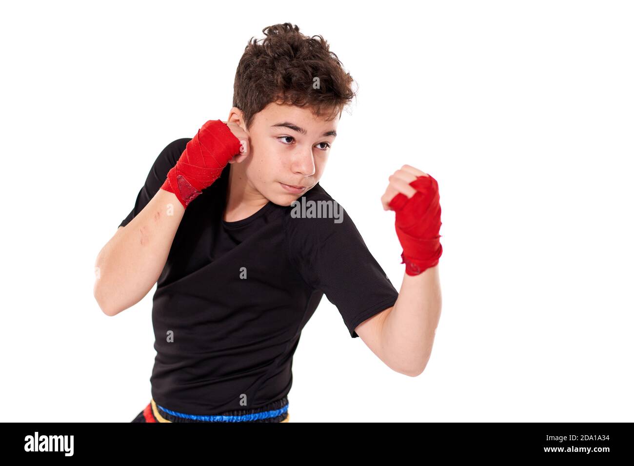 Young kickboxer training shadow boxing, isolated on white background ...