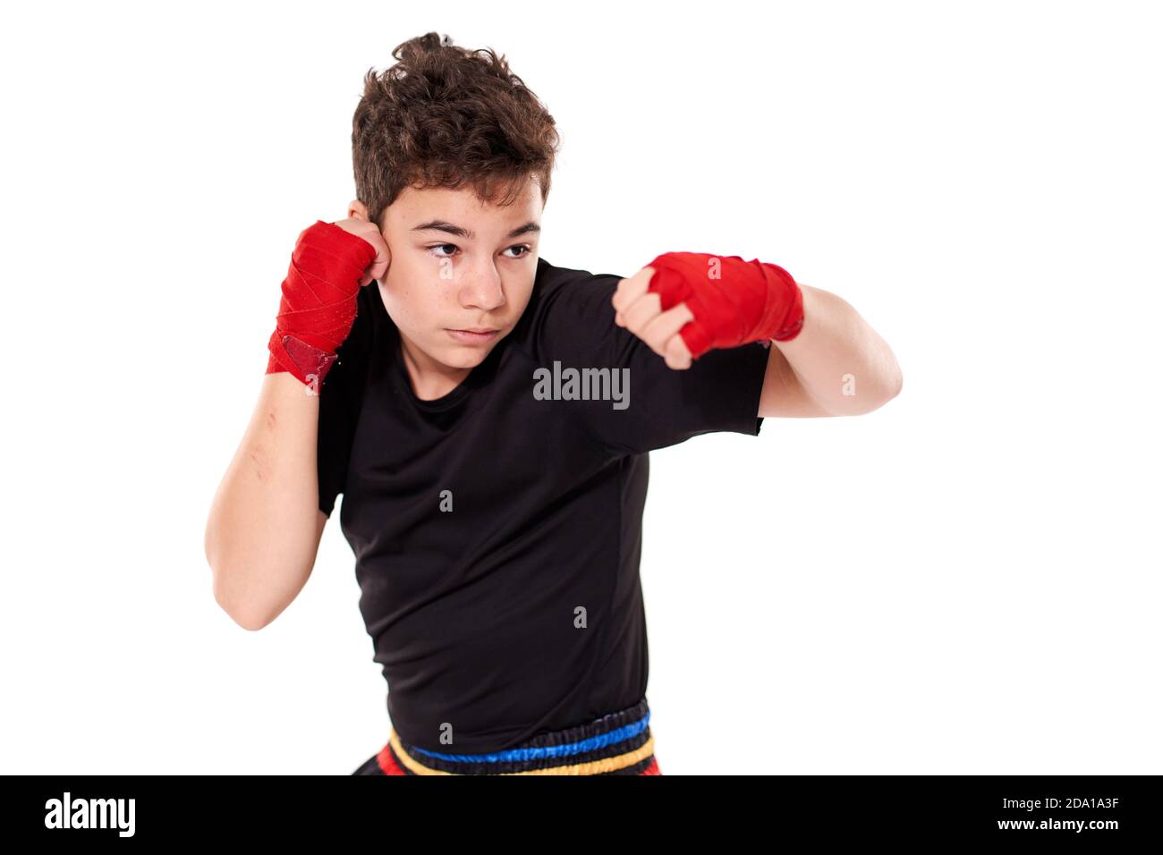 Young kickboxer training shadow boxing, isolated on white background ...