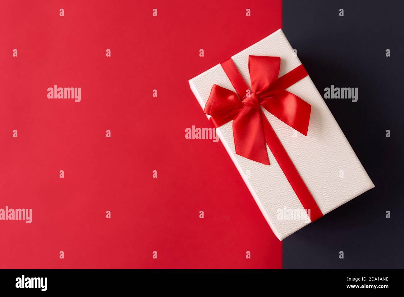 White present with red ribbon on the bright red background Stock Photo ...