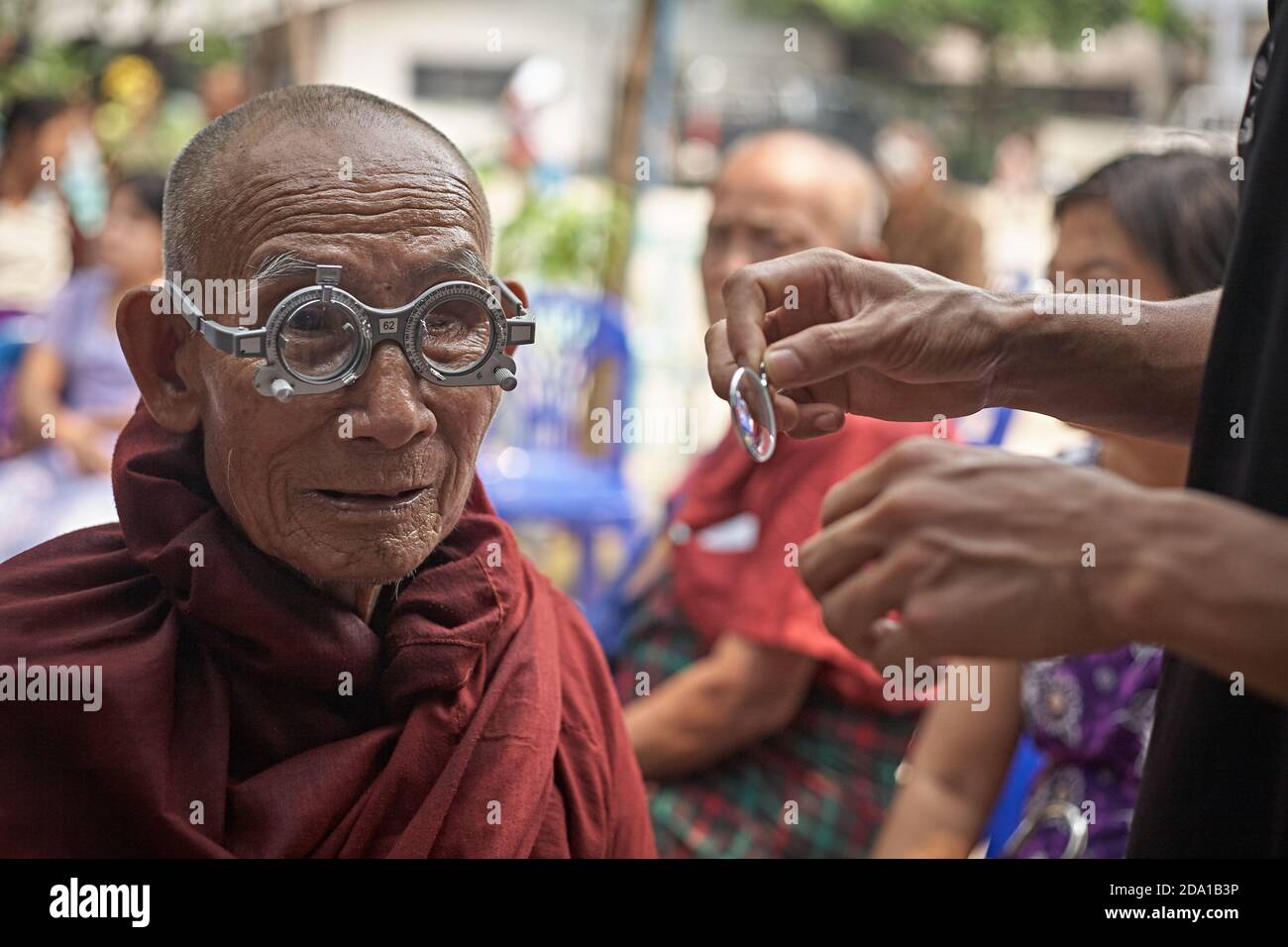 Mae Sot, Thailand. April 2012. A Buddhist monk performs an eye test at ...