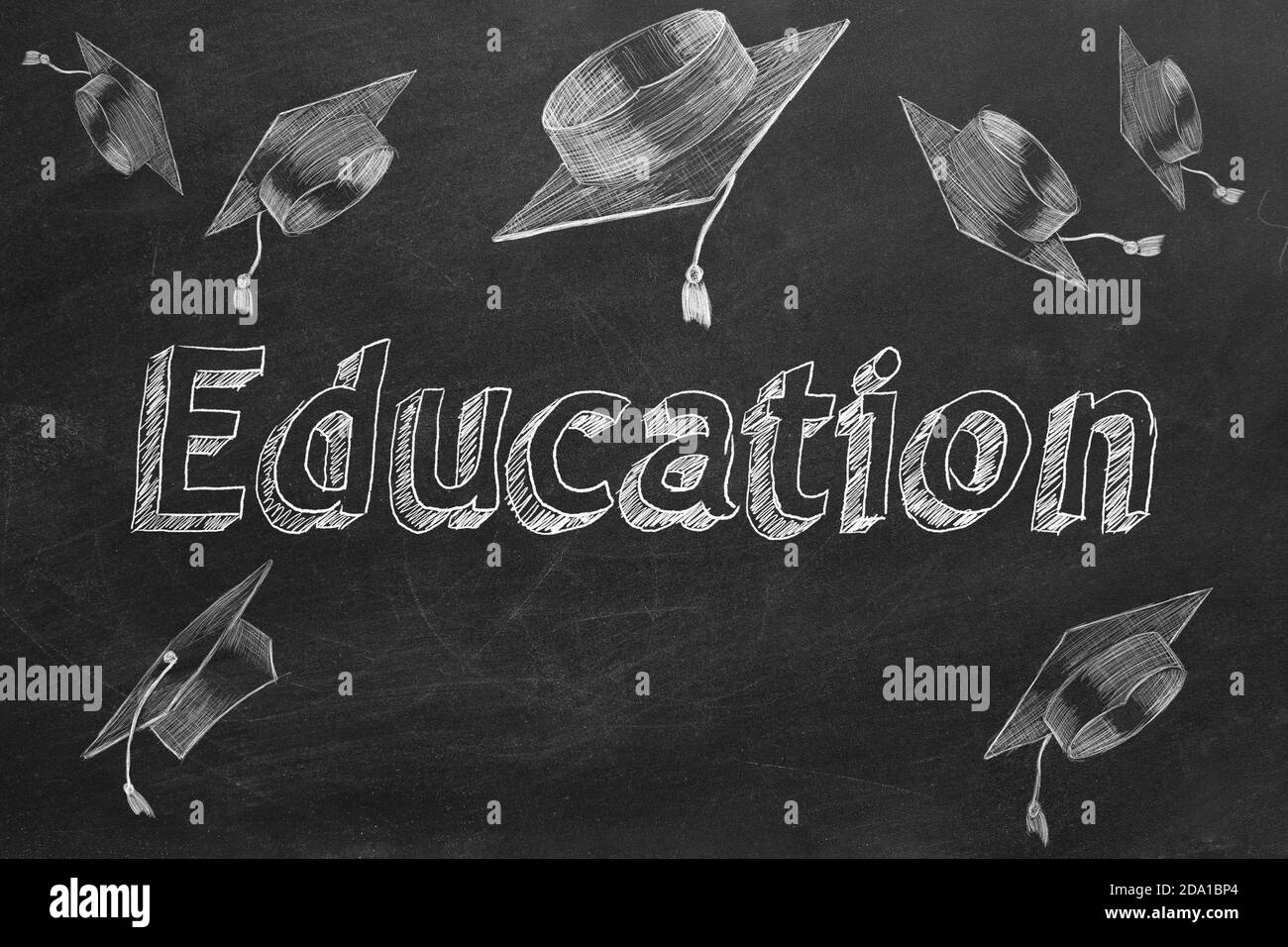Hand drawing "Education" and graduation caps on blackboard Stock Photo ...