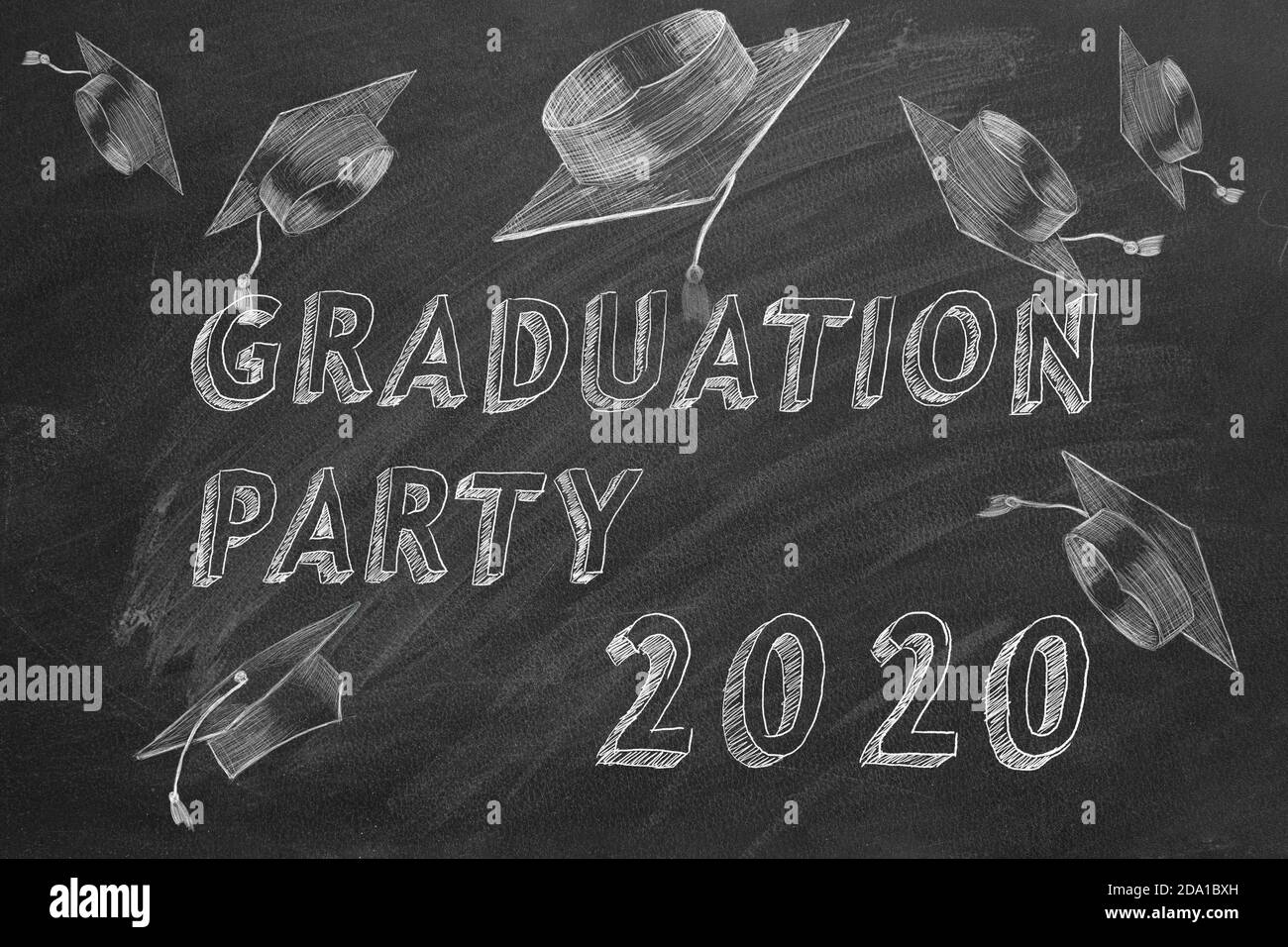 Hand drawing text "Graduation party 2020" and graduation caps on ...