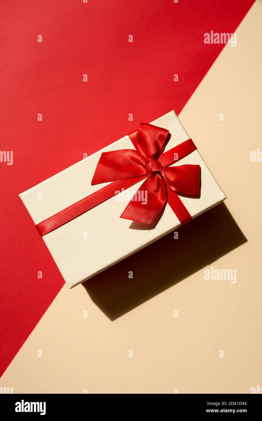 White present with red ribbon on the bright red background Stock Photo ...
