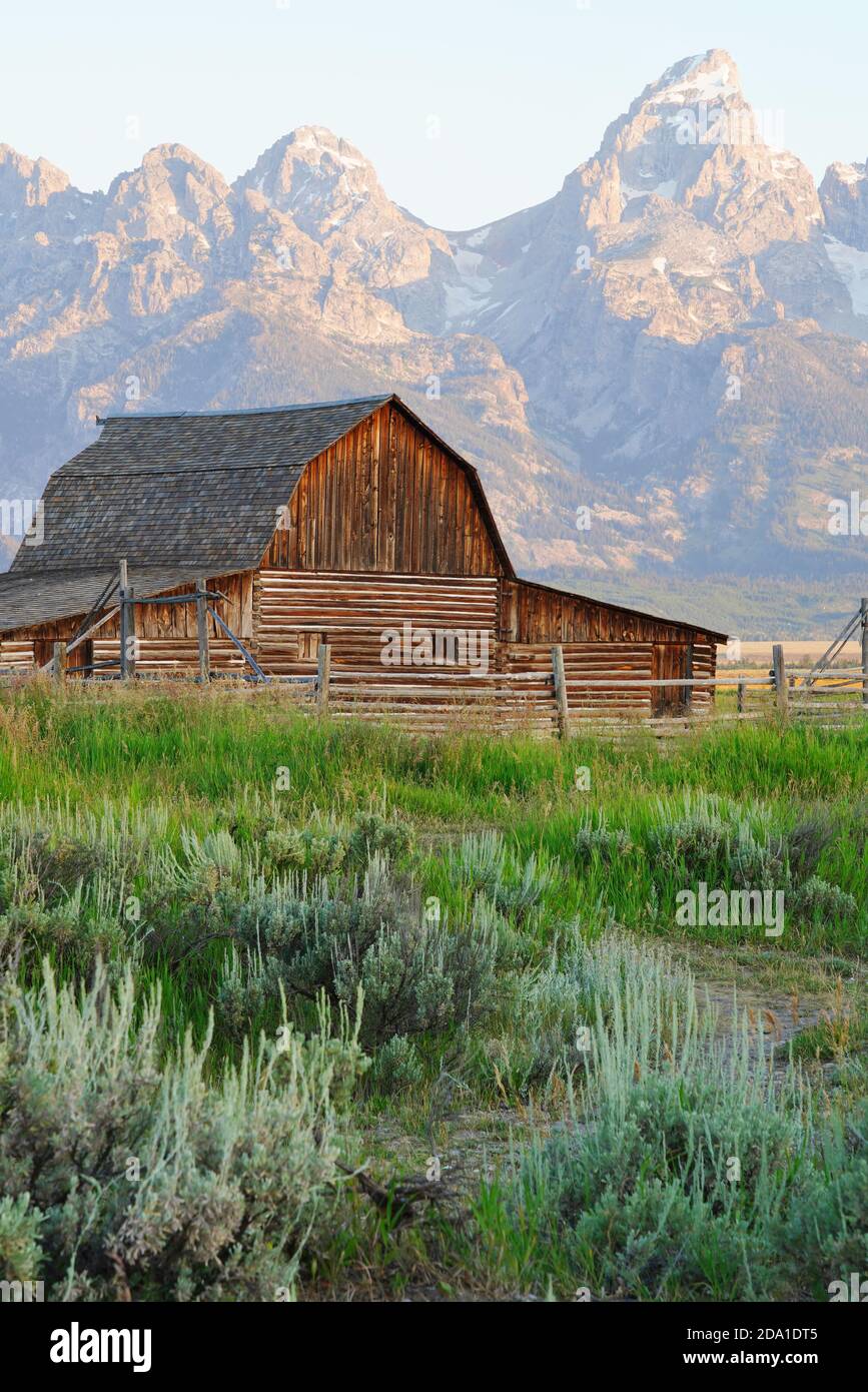 Sunrise over a log cabin on Mormon Row Historic District in Antelope ...