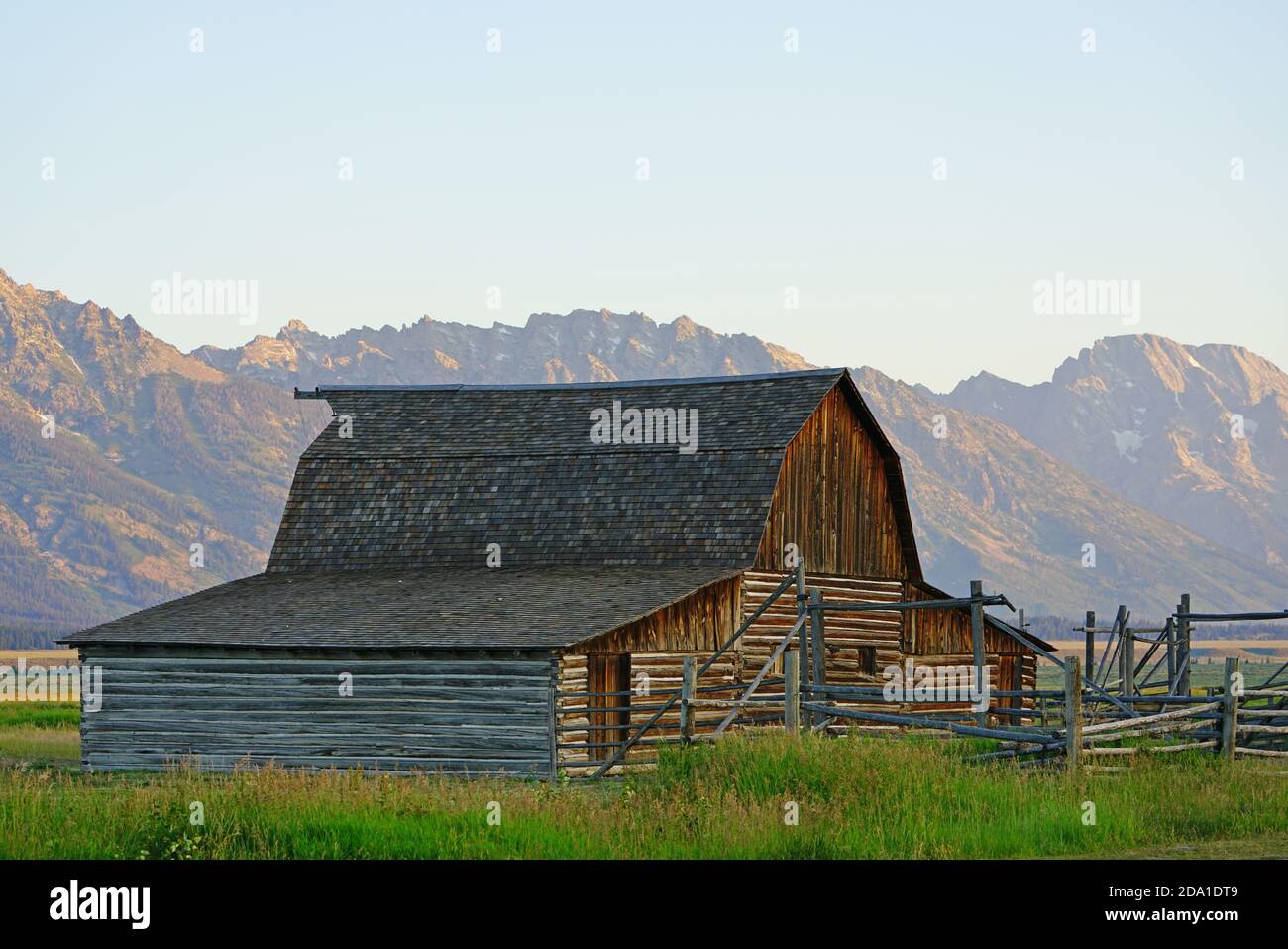 Sunrise over a log cabin on Mormon Row Historic District in Antelope ...