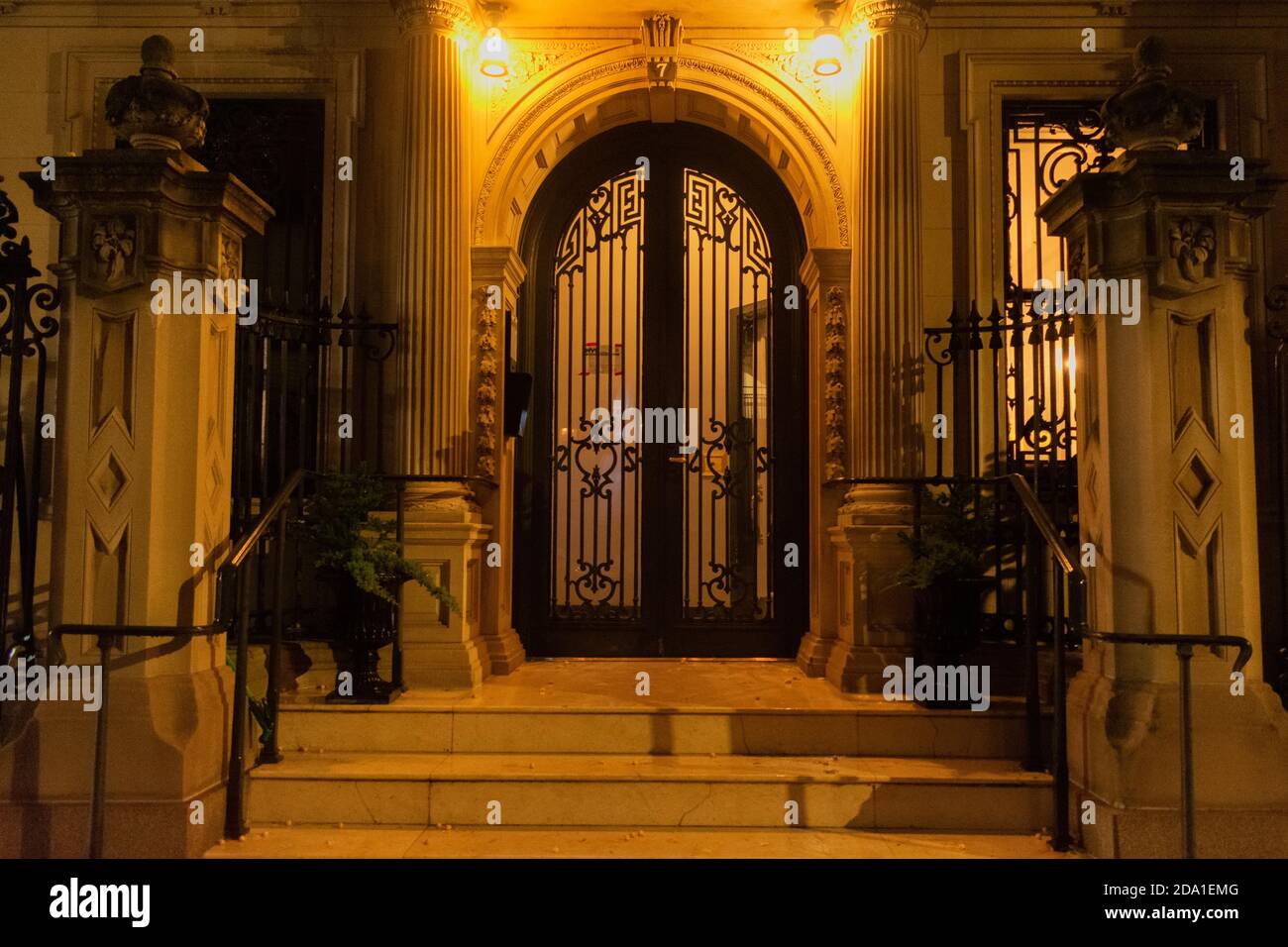 Steps towards the door of a luxurious mansion under the lights at night ...