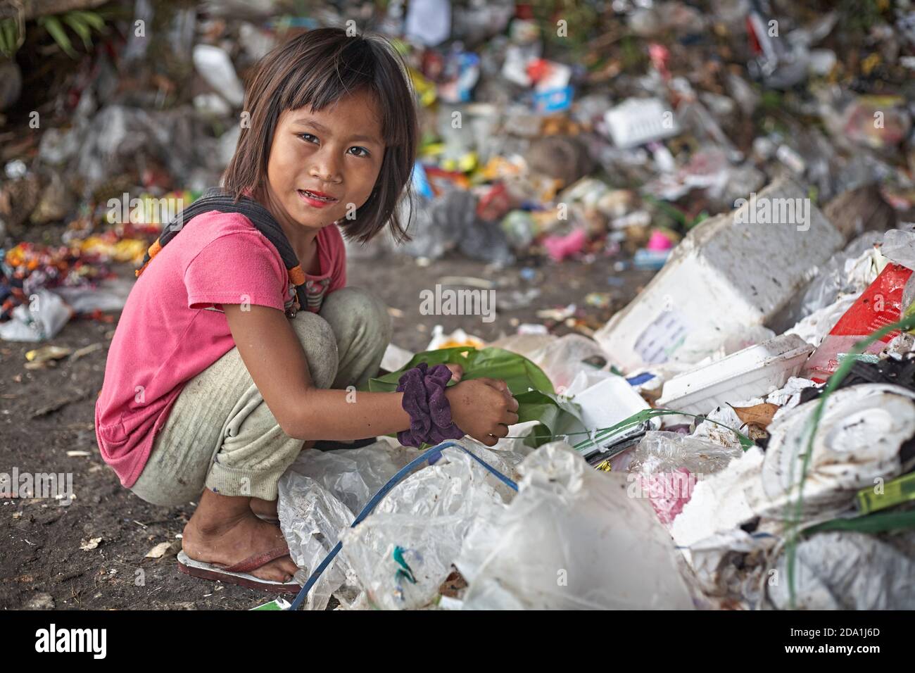 Mae Sot, Thailand. April 2012. Myanmar's refugee child labourers searching the city's rubbish ...