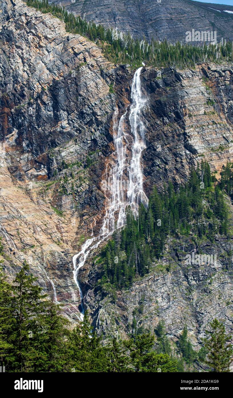 Water falls down mountains in Glacier National Park Stock Photo - Alamy