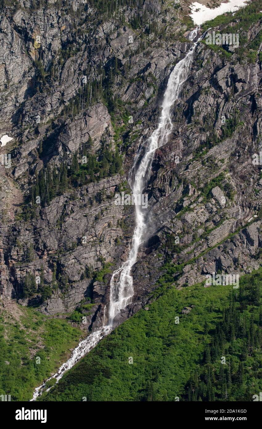 Water falls down mountains in Glacier National Park Stock Photo - Alamy