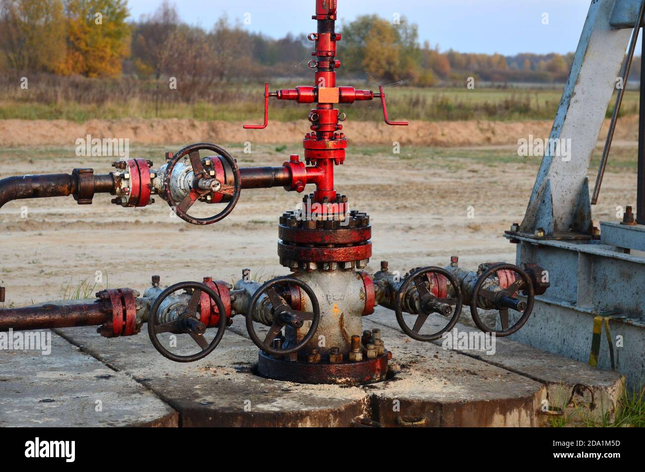 Industrial piping with steel flanges and bolts on oil field. Fuel pipes ...