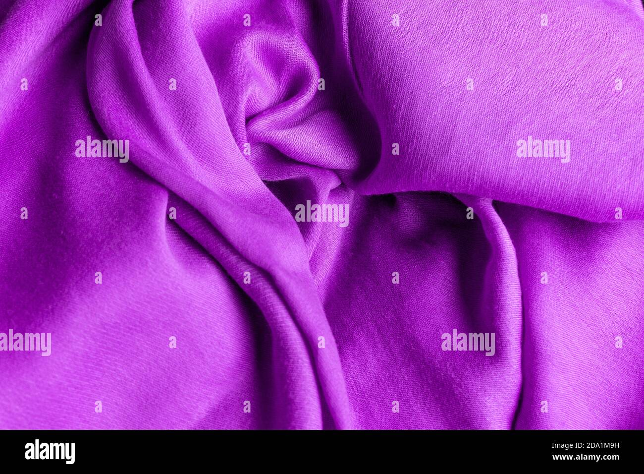 purple silk background, satin fabric, violet textile, flatlay of a blue ...