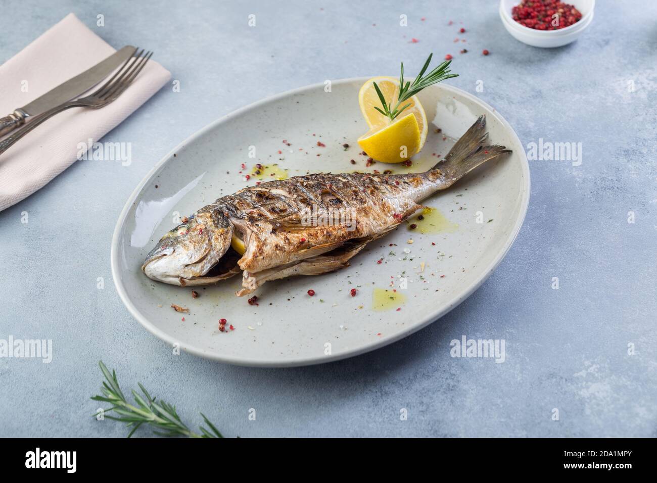 Delicious baked fish with lemon and spices from the chef. Original ...