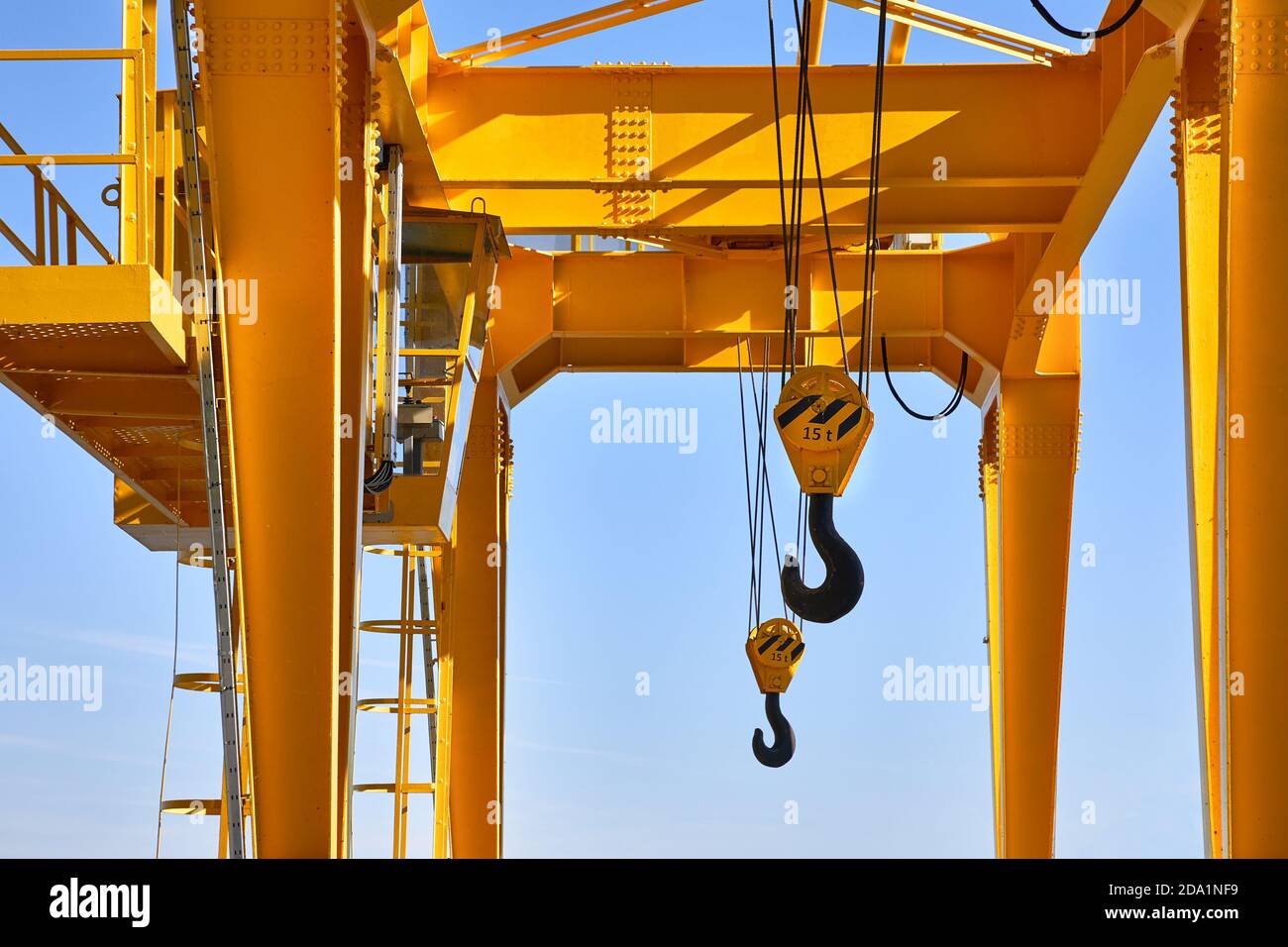 Crane with hooks hanging Stock Photo - Alamy