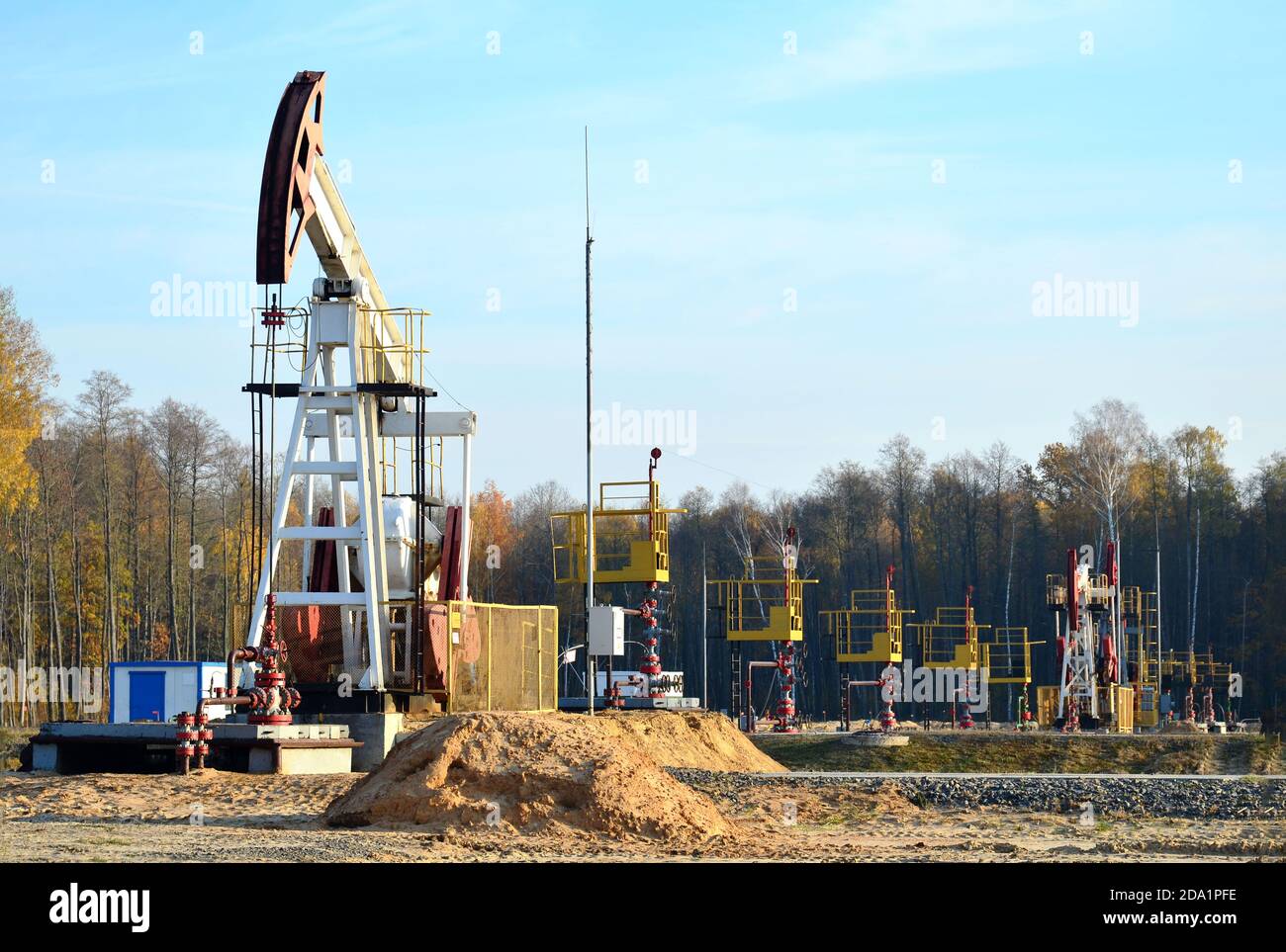 Oil drilling derricks at desert oilfield for fossil fuels output and ...