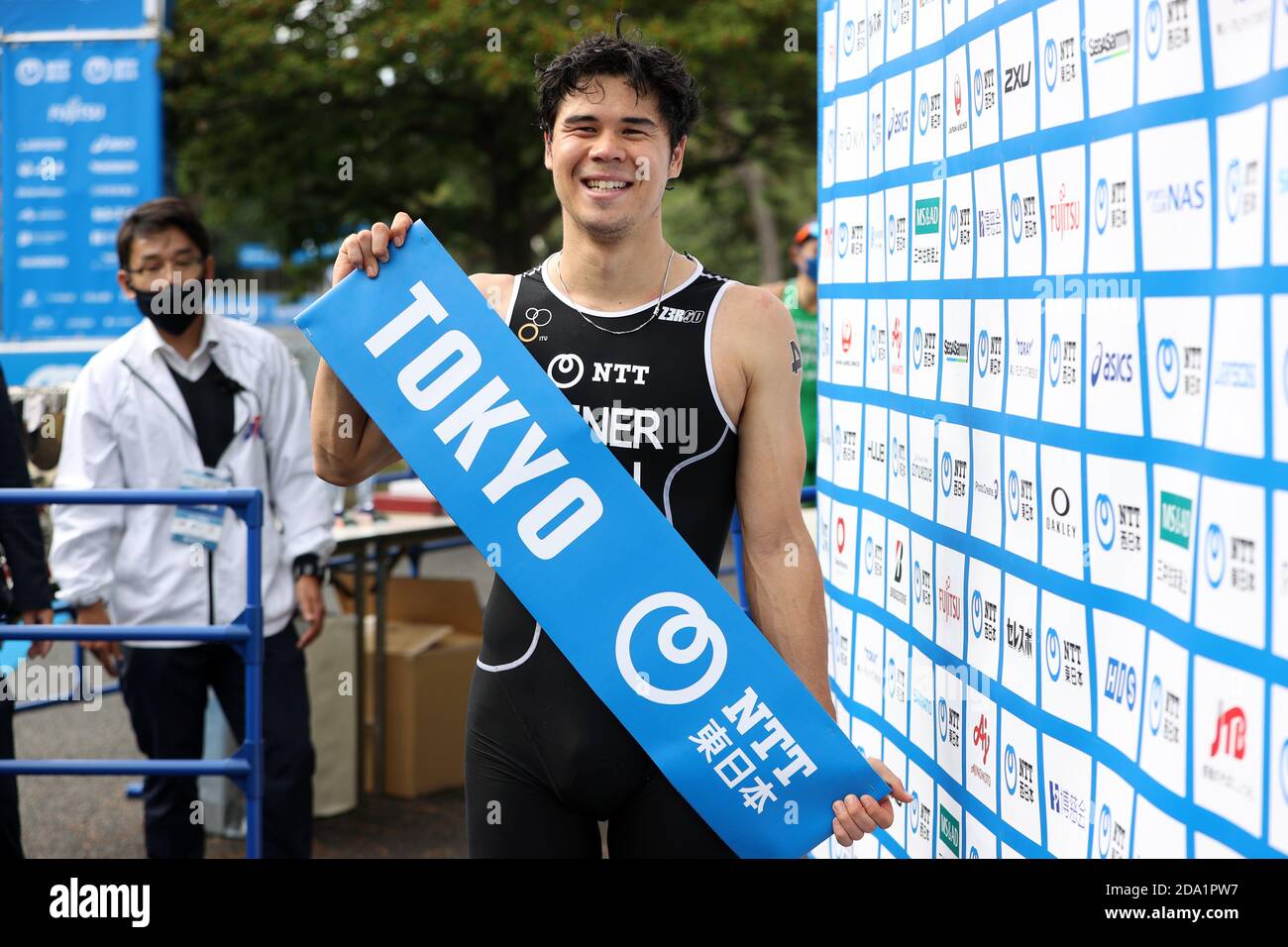 Winner Kenji Nener celebrates during the 26th Japan Triathlon ...