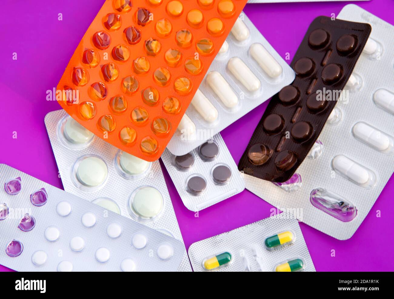 Many colorful tablets and medicines drugs in plastic pharmaceutical ...