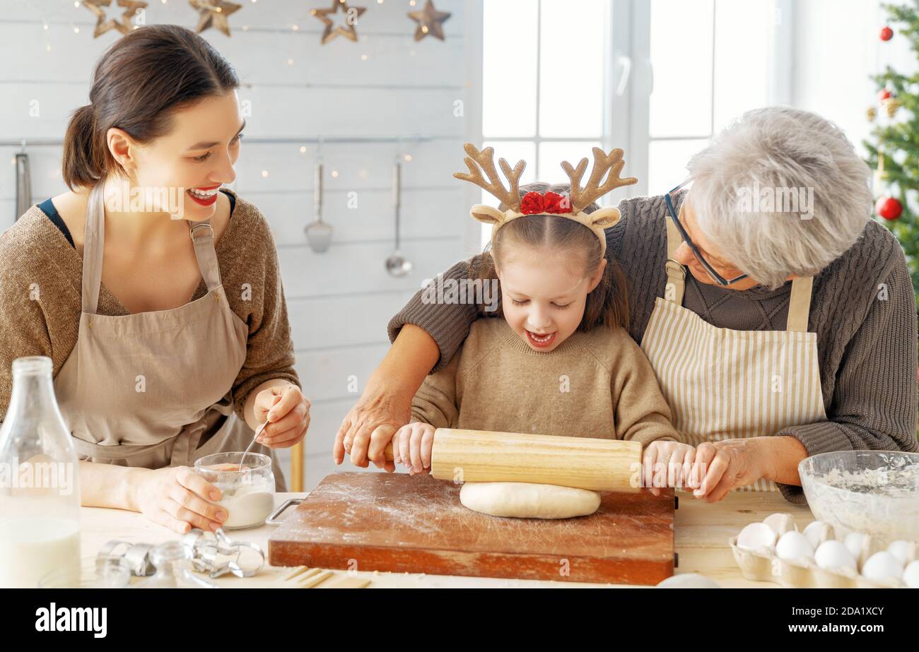 Merry Christmas and Happy Holidays. Family preparation holiday food ...
