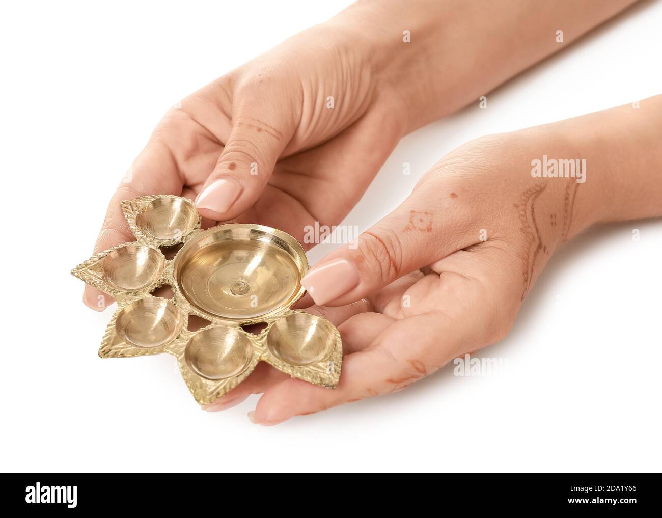 Female hands with diya lamp for celebration of Divaly on white ...