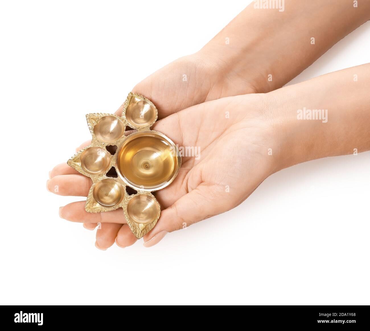 Female hands with diya lamp for celebration of Divaly on white ...