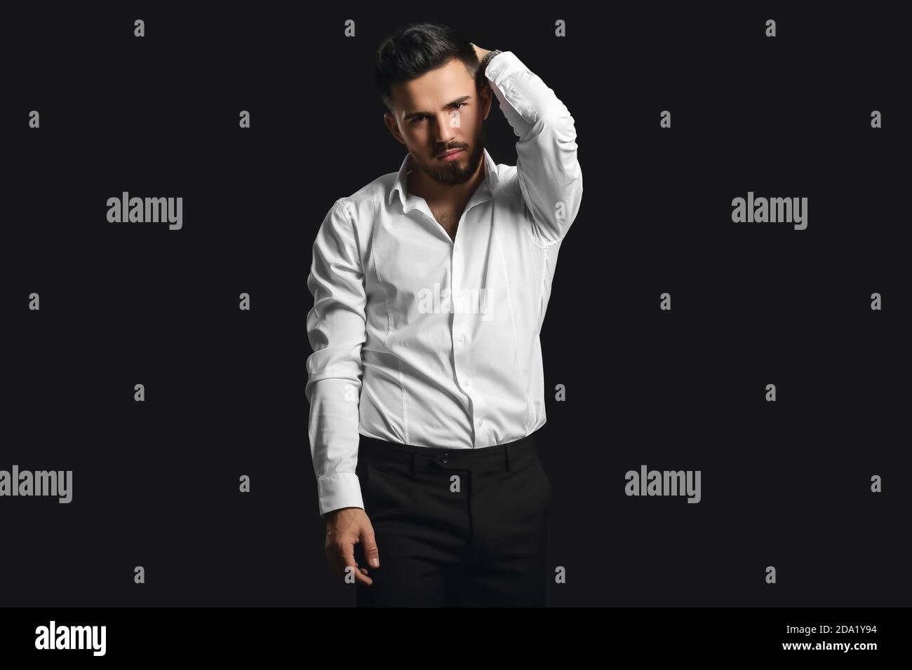 Fashionable young man on dark background Stock Photo - Alamy