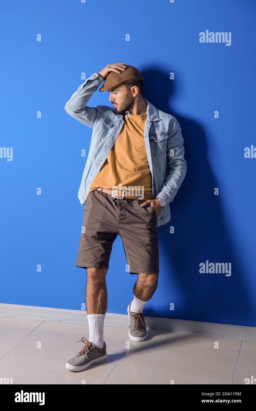 Fashionable young man on color background Stock Photo - Alamy