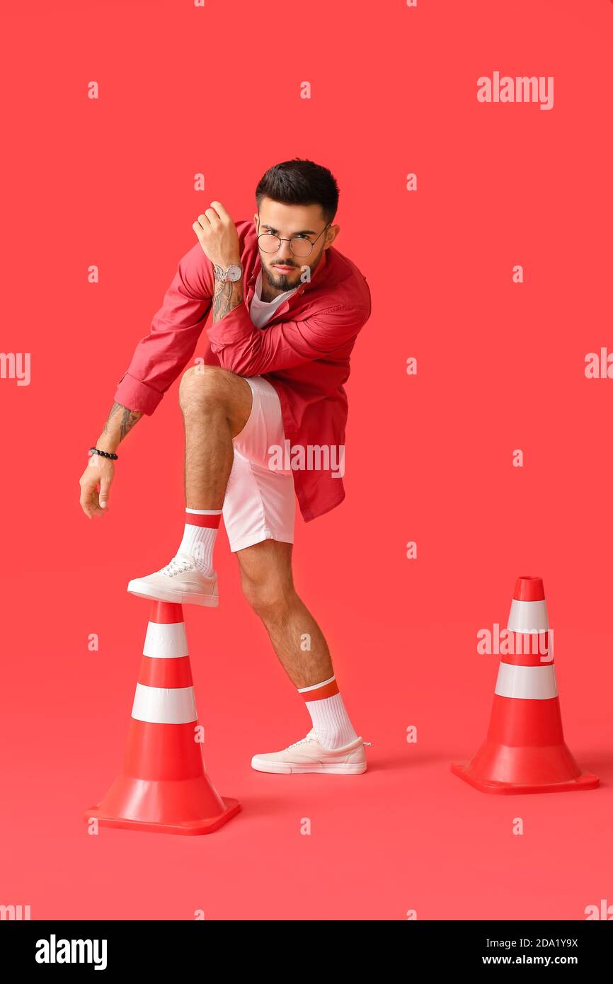 Fashionable young man on color background Stock Photo - Alamy