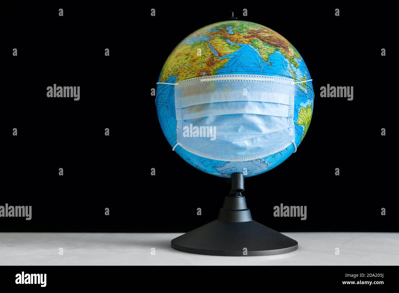 Earth globe in sterile medical mask at the table Stock Photo - Alamy