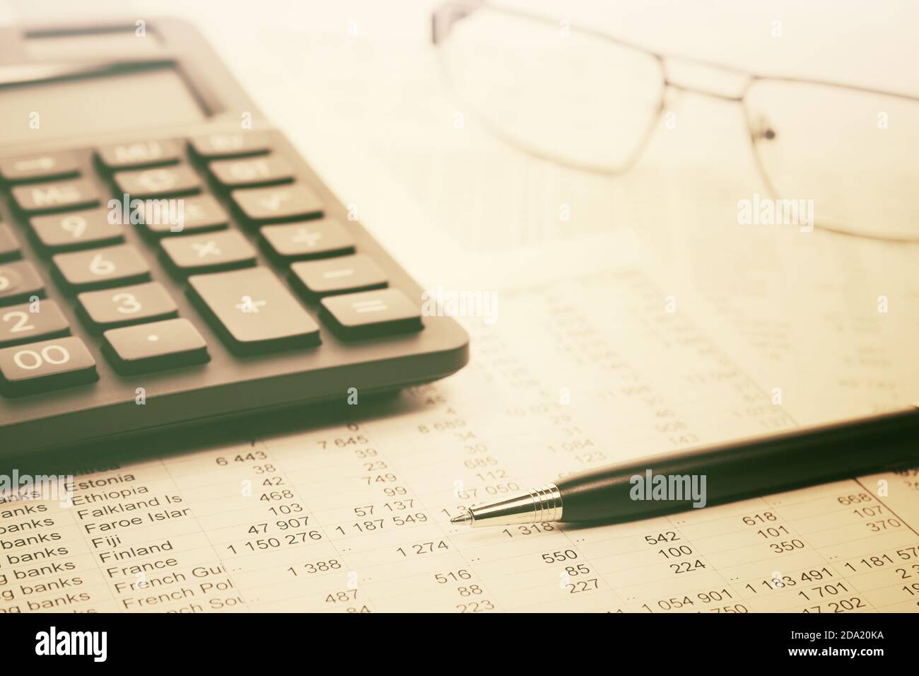 Financial accounting Pen and calculator on balance sheets Stock Photo ...