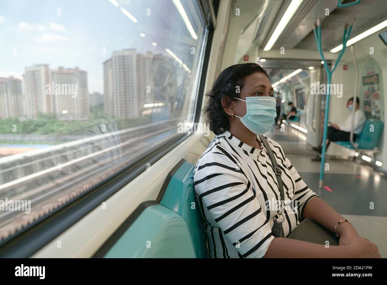Woman commuter wearing face mask inside subway train. Travel new normal ...