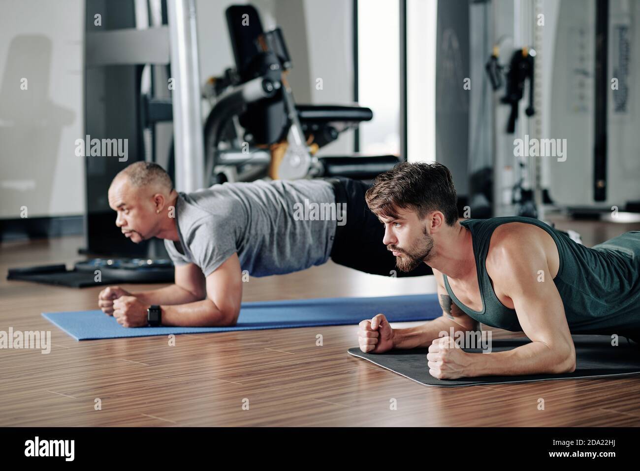 Men standing in plank position Stock Photo - Alamy